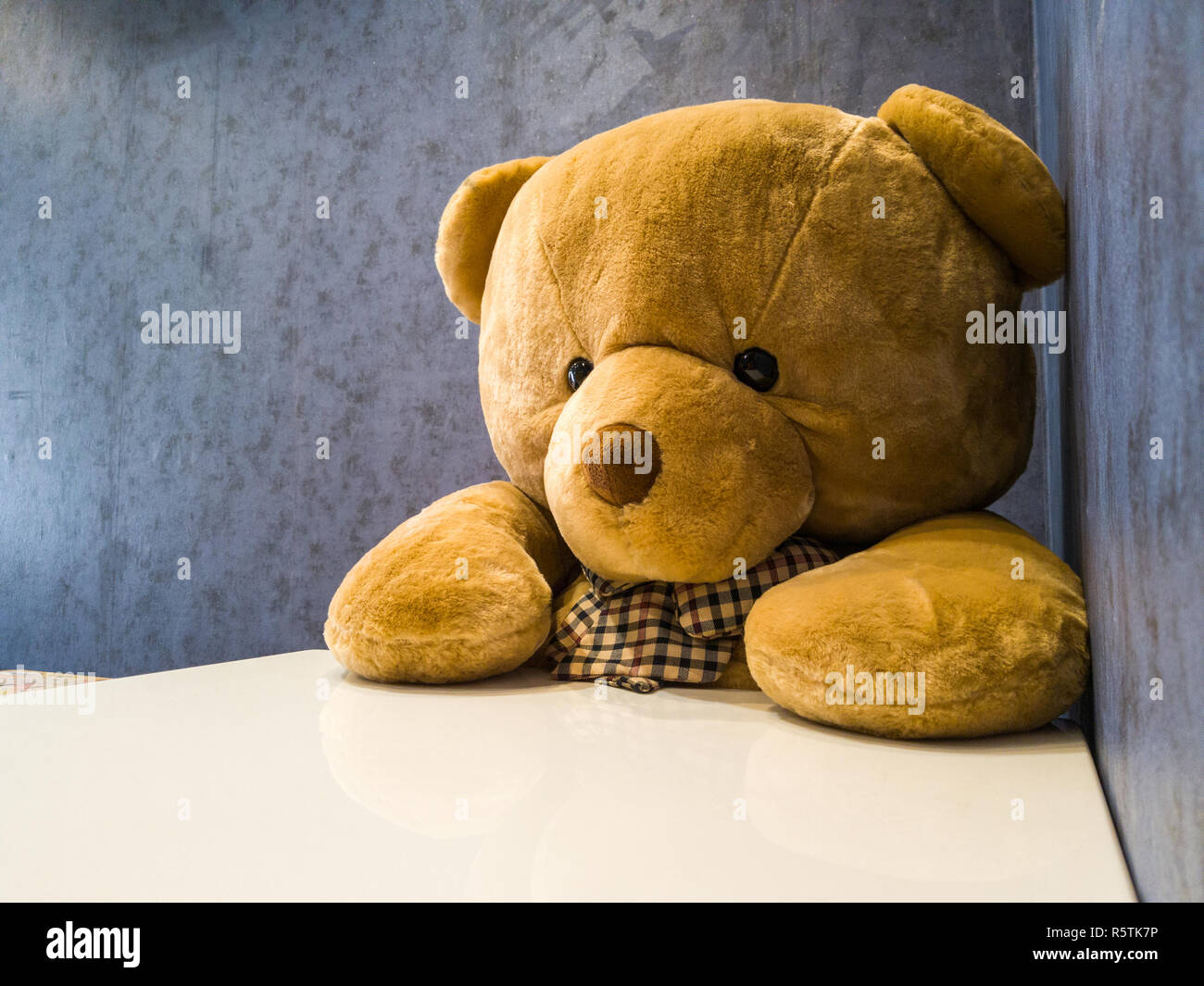 Cute teddy bear sit on the chair in front of dining table. Make it seem ...