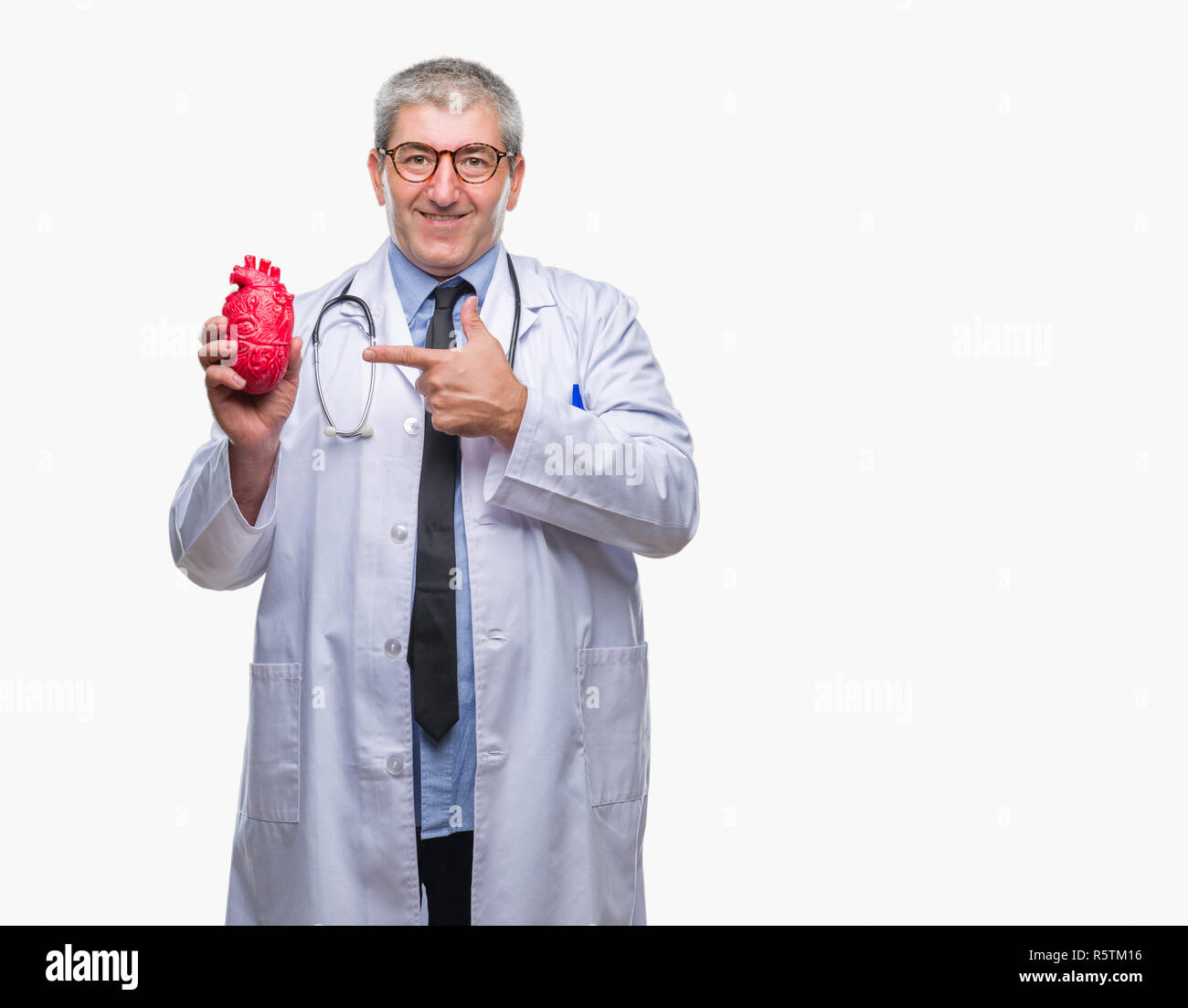 Handsome senior cardiologist doctor man holding heart over isolated ...