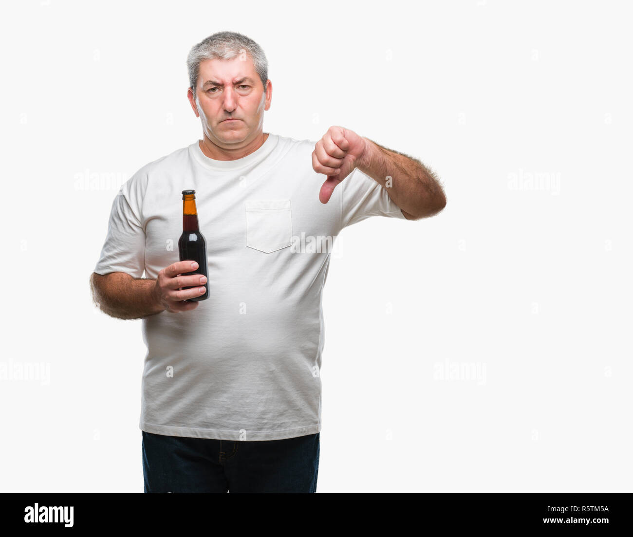 Handsome senior man drinking beer bottle over isolated background with ...