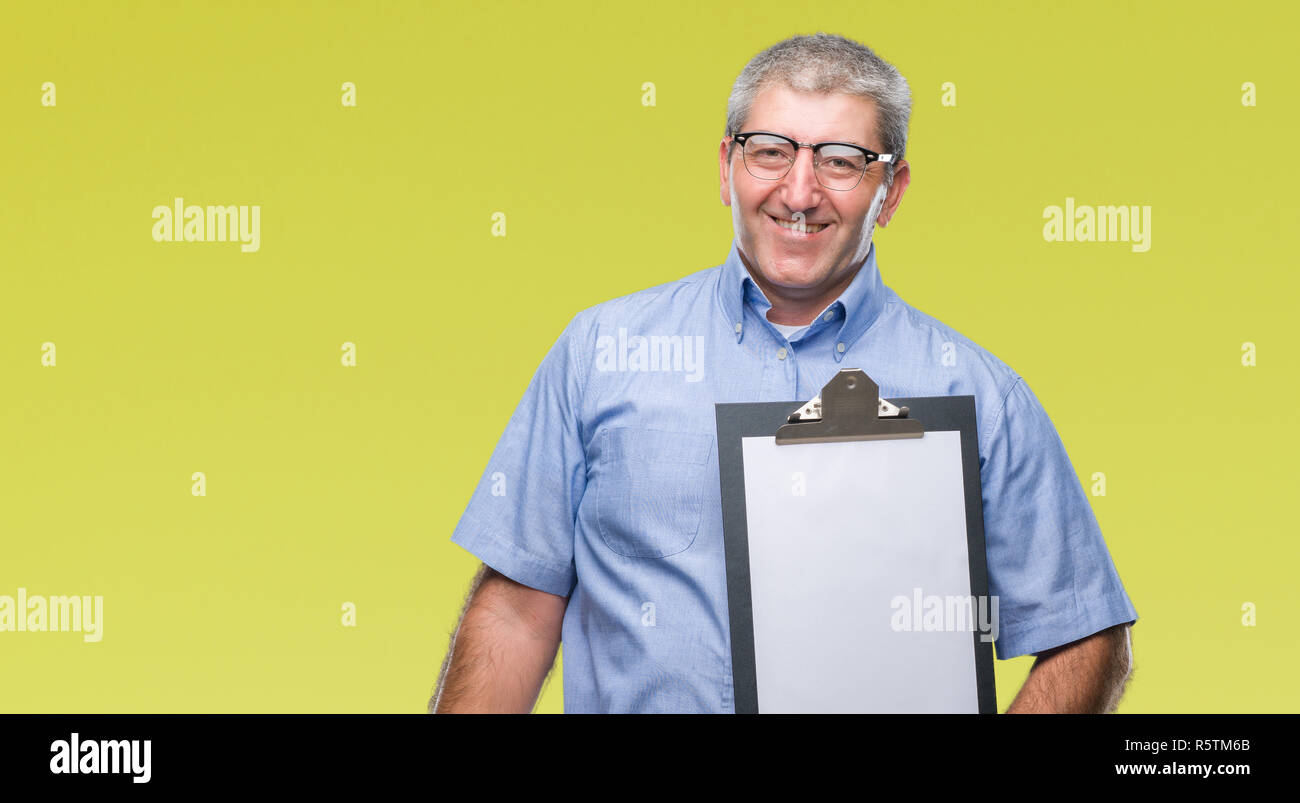 Handsome senior inspector man holding clipboard over isolated ...
