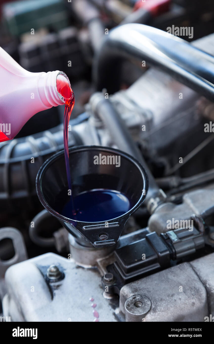Pouring oil to a car engine with a funnel Stock Photo - Alamy