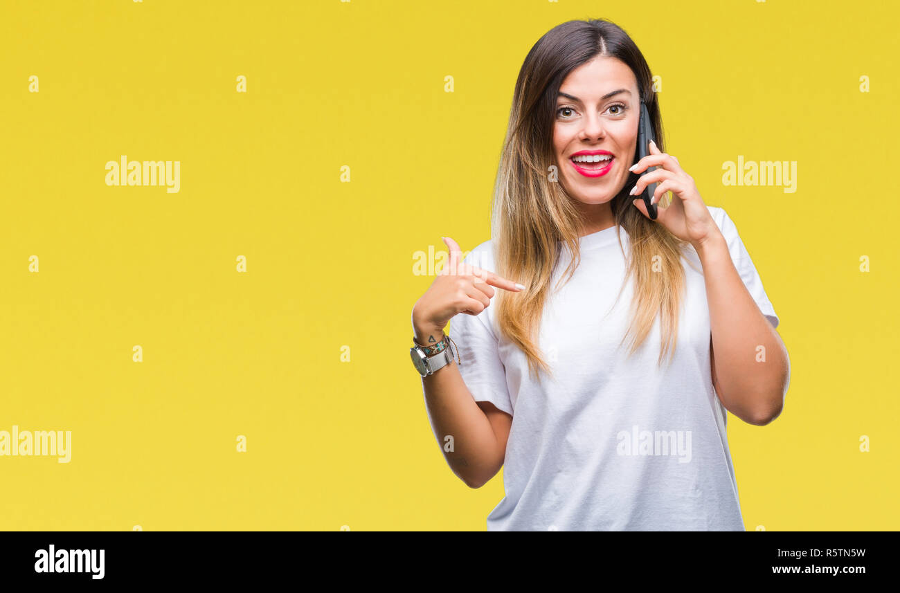 Young beautiful woman speaking calling using smartphone over isolated ...