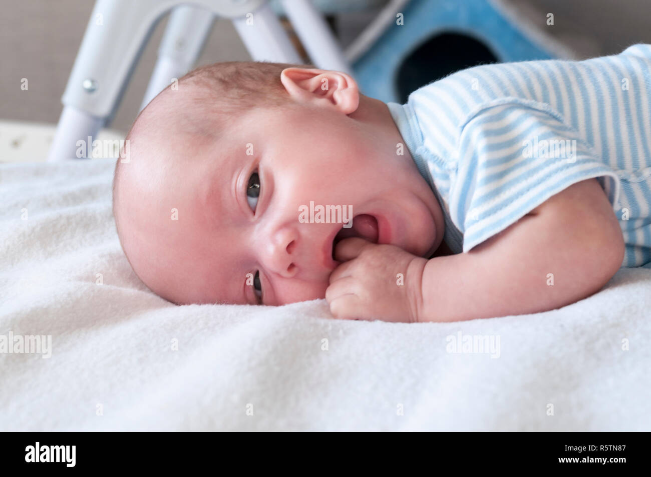 The baby cries and pulls the handle into his mouth because of the ...