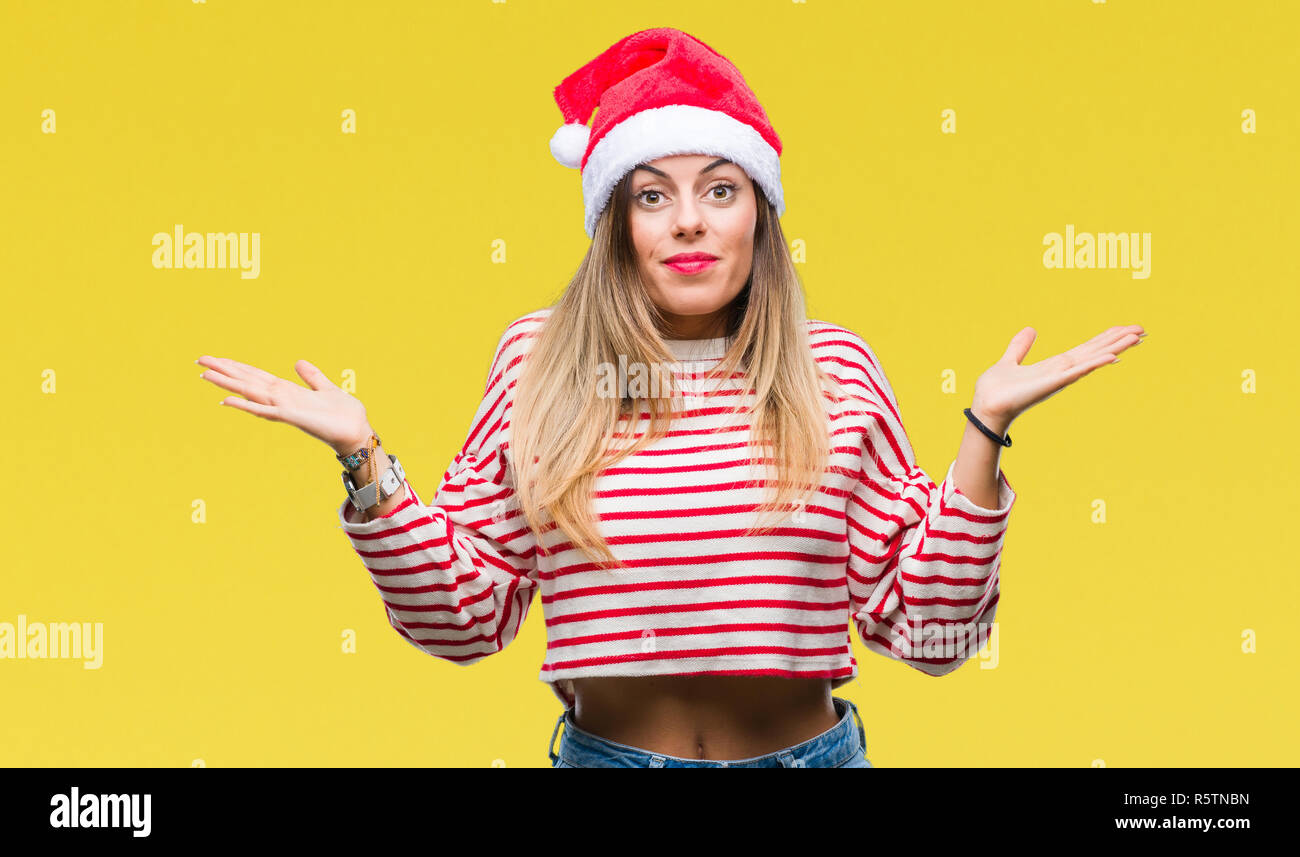 Young beautiful woman wearing christmas hat over isolated background ...