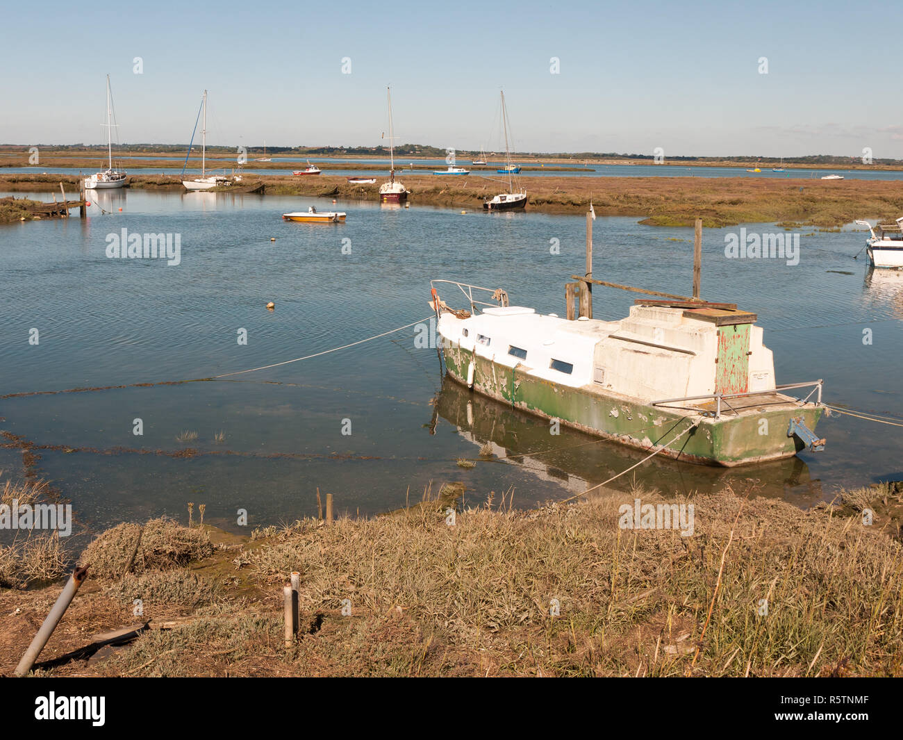 moored boat in estuary river stream tollesbury essex marsh land scene ...