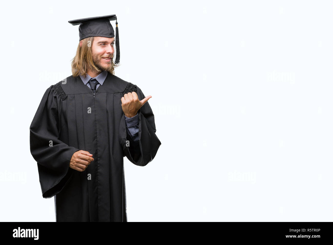 Young handsome graduated man with long hair over isolated background ...