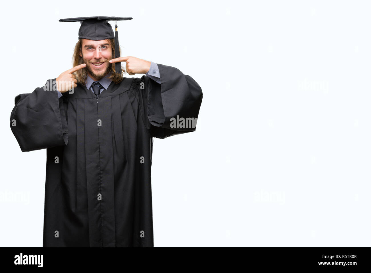 Young handsome graduated man with long hair over isolated background ...