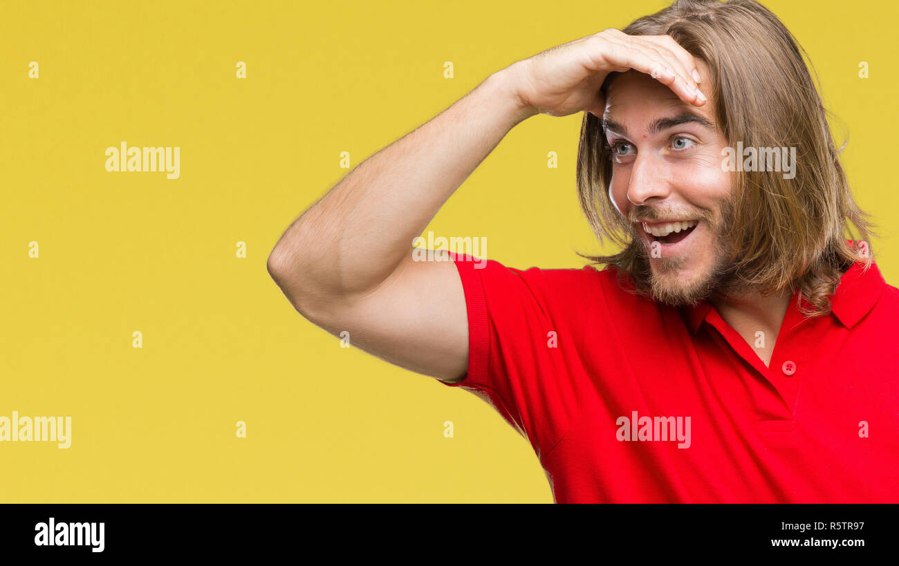 Young handsome man with long hair over isolated background very happy ...
