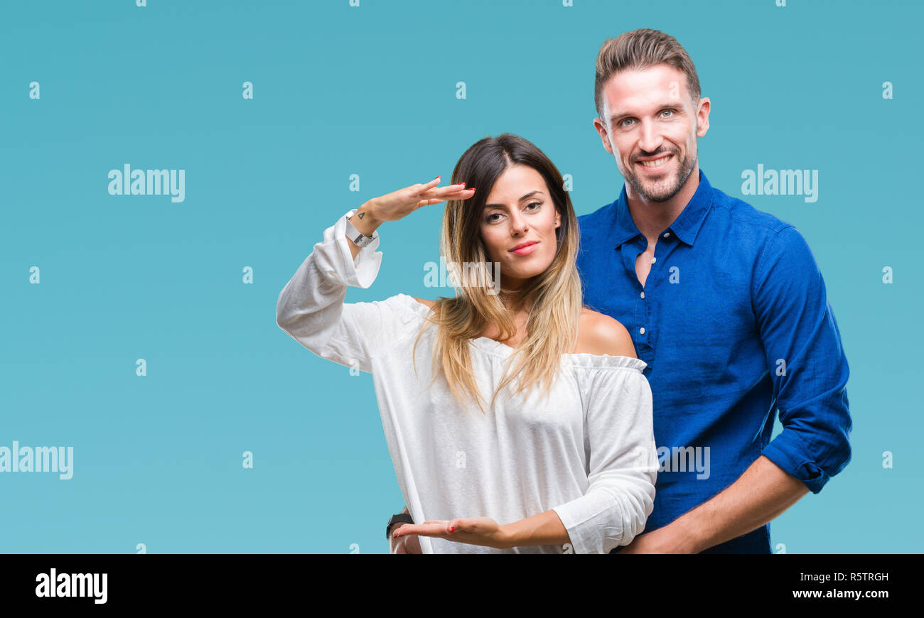 Young couple in love over isolated background gesturing with hands ...
