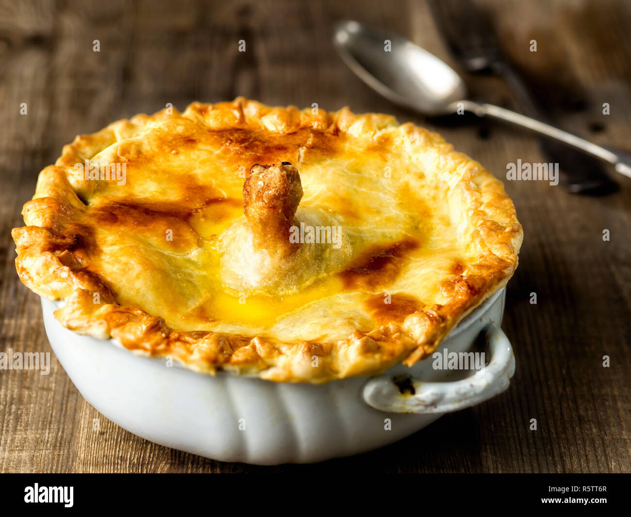 close up of golden rustic english chicken pie Stock Photo - Alamy