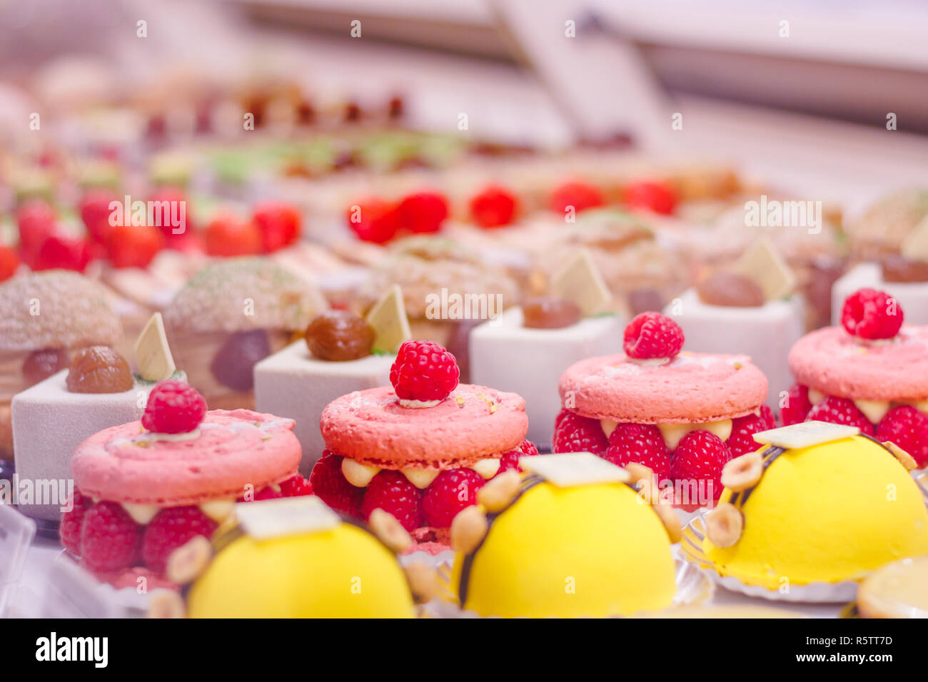 Beautiful delicious pastries with raspberry on a showcase in a French ...