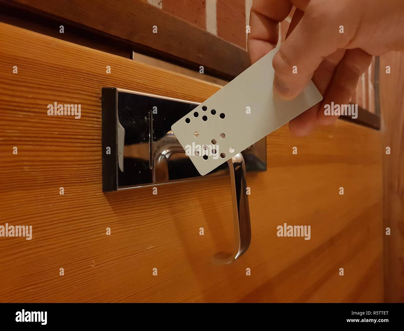 Close up Image of analog punchcard as a key to open hotel room door ...