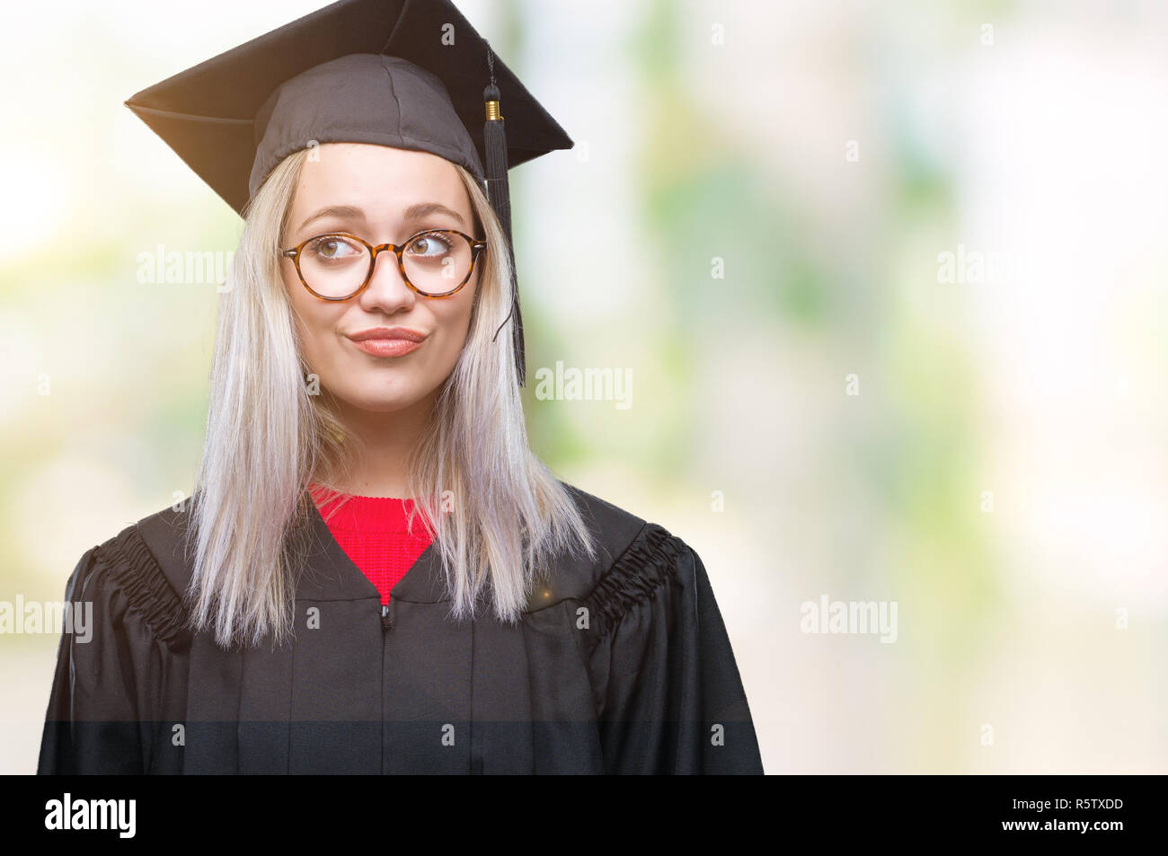 Young blonde woman wearing graduate uniform over isolated background ...