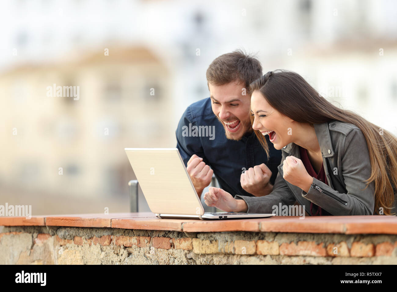 Couple excited laptop hi-res stock photography and images - Alamy