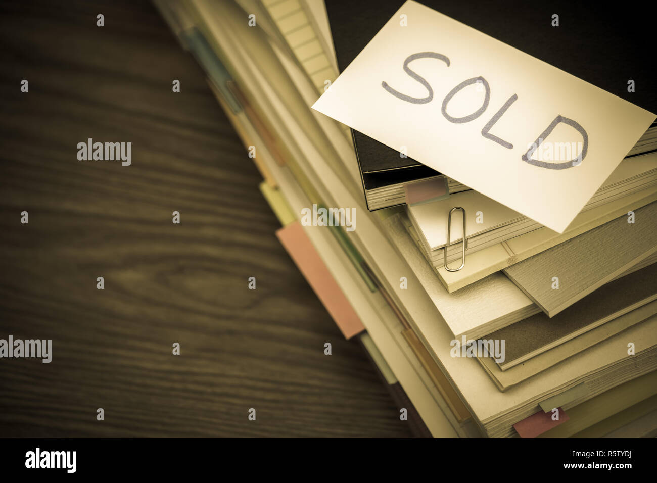 Sold The Pile of Business Documents on the Desk Stock Photo - Alamy