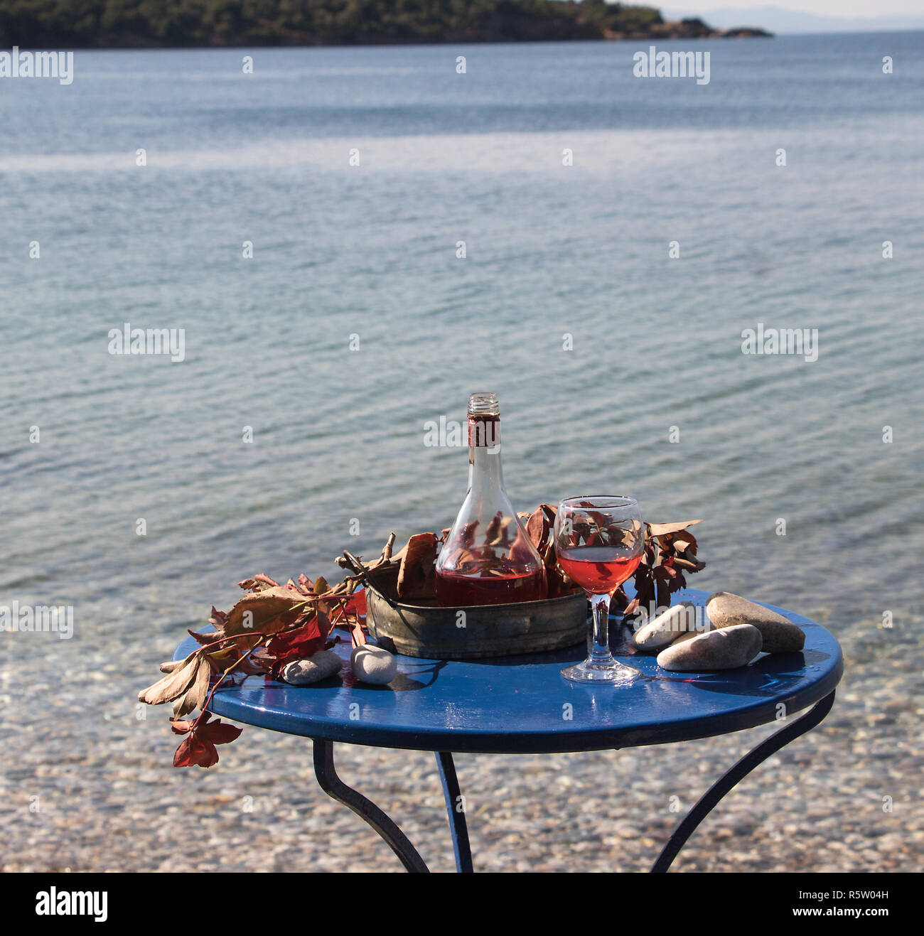 greek coffee house by the sea with red wine and flotsam Stock Photo - Alamy