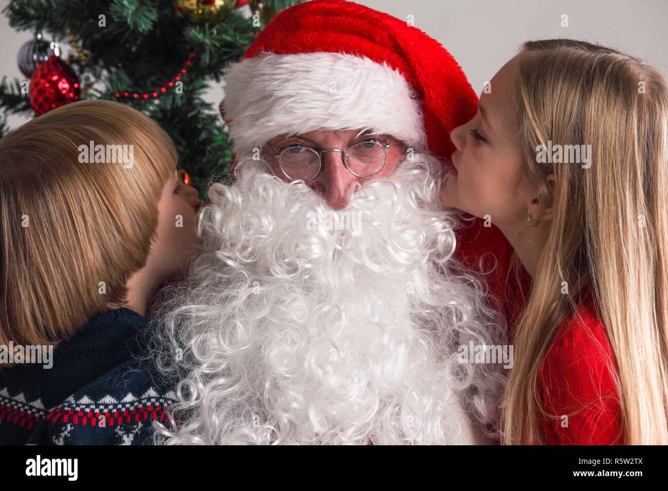 Two Children whispering to Santa Claus ear Suggesting desires Stock ...