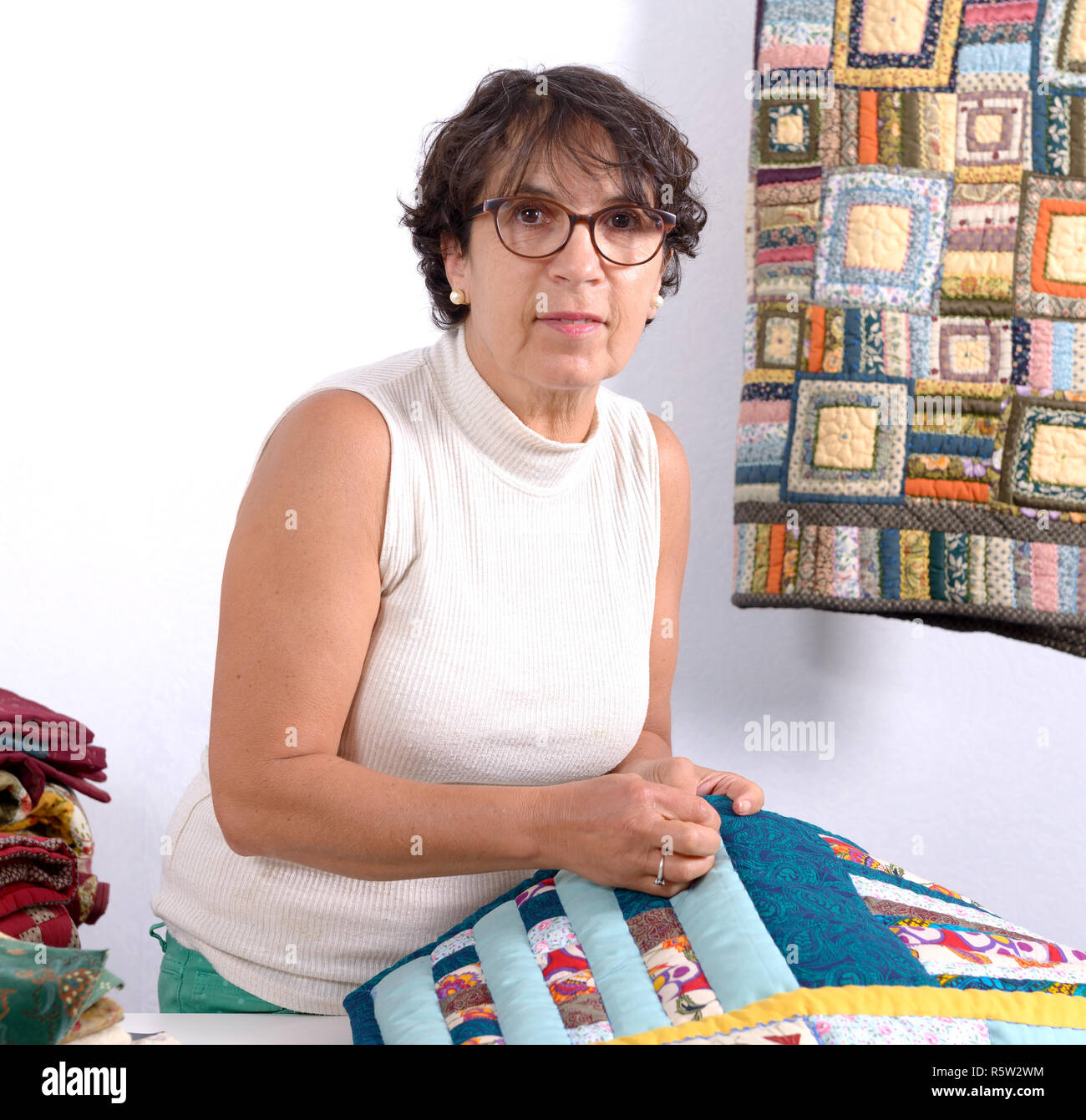 mature brunette woman sewing patchwork Stock Photo - Alamy