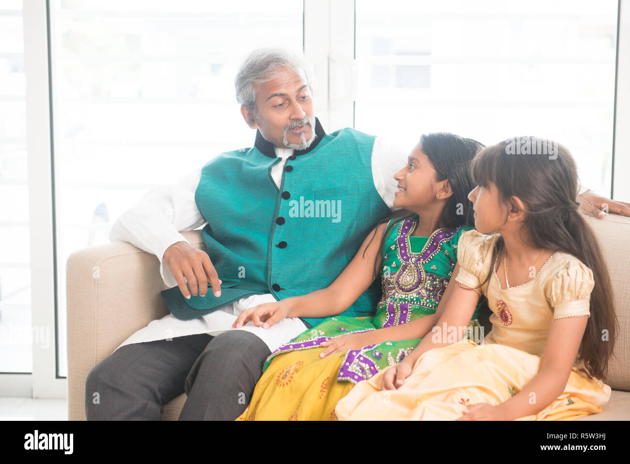 Happy Indian father and daughters bonding Stock Photo - Alamy