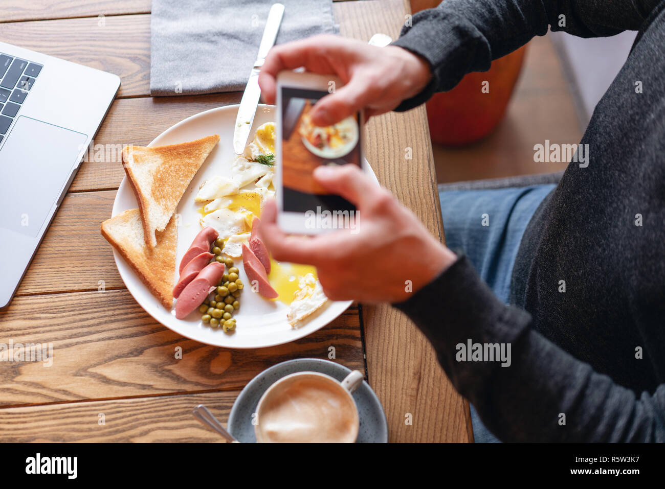 Blogger takes pictures of the Breakfast on the smartphone. Concept of ...