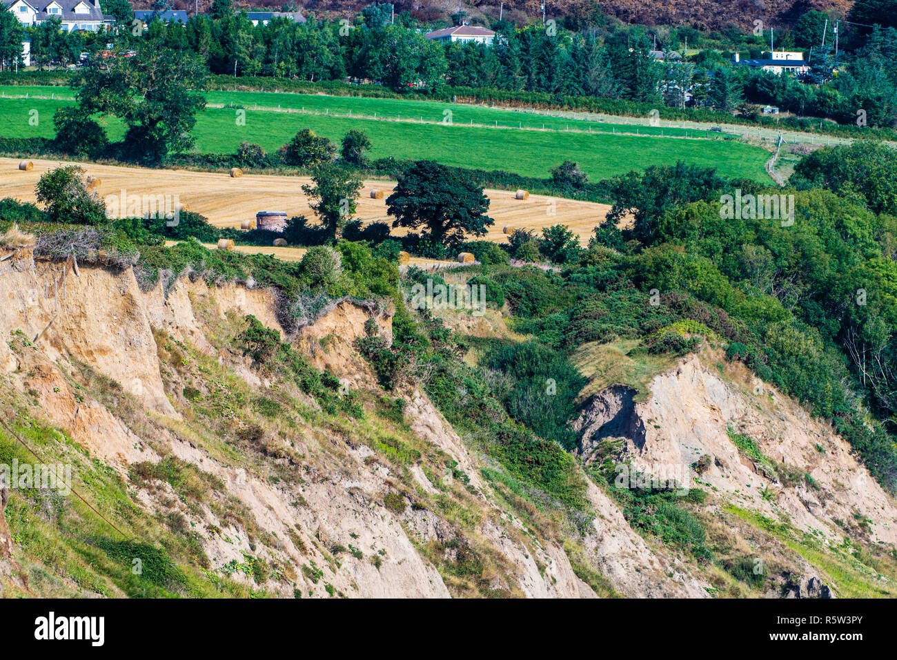 Farmland over steep cliff Stock Photo - Alamy
