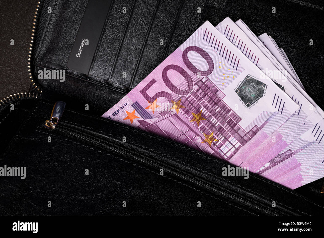 leather black wallet full of euro bank notes Stock Photo - Alamy