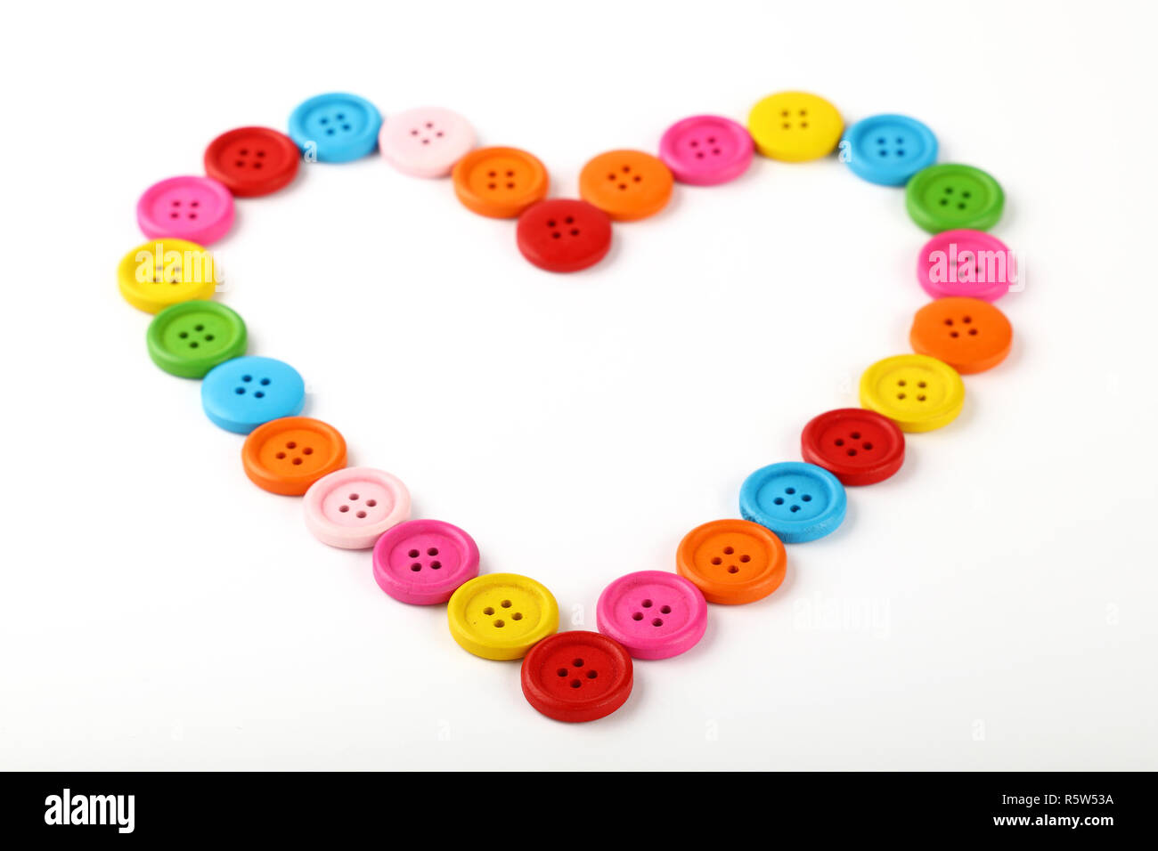 Heart shaped of colorful sewing buttons on white Stock Photo - Alamy
