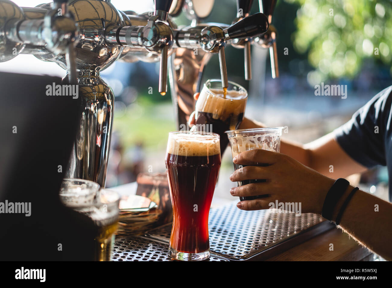 Closeup hand serving beer glass hi-res stock photography and images - Alamy
