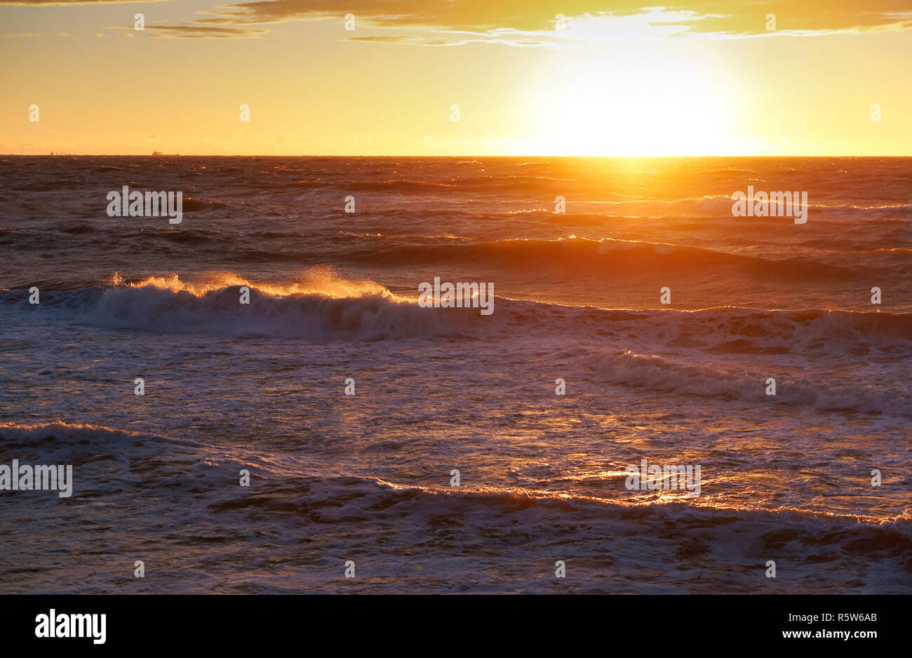Sunset over the sea. Reflection of sunlight in the sea waves. Red sky ...