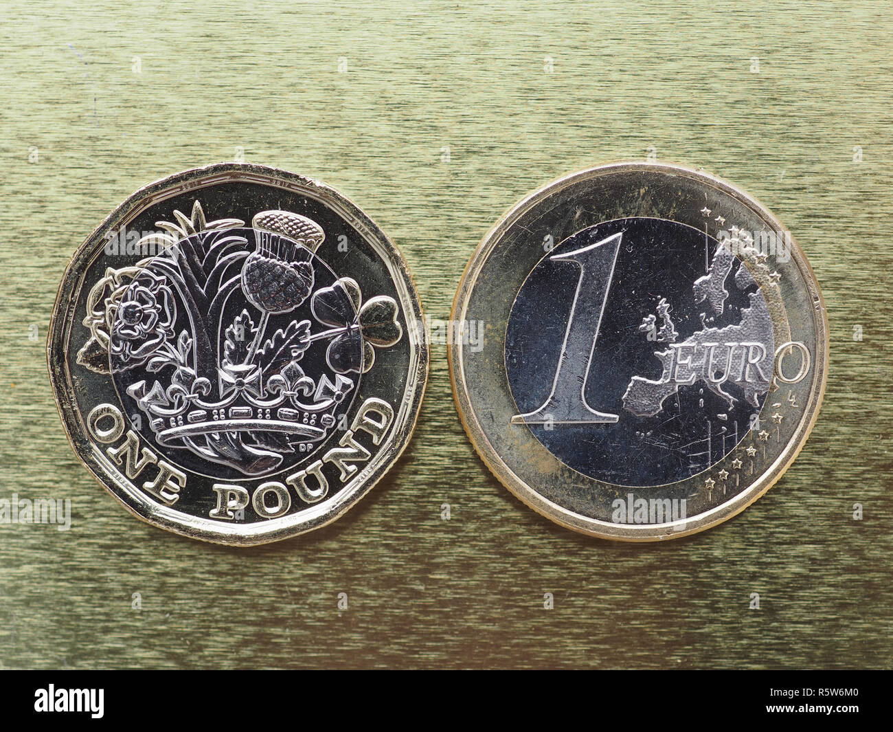 1 pound and 1 euro coin over metal background Stock Photo - Alamy