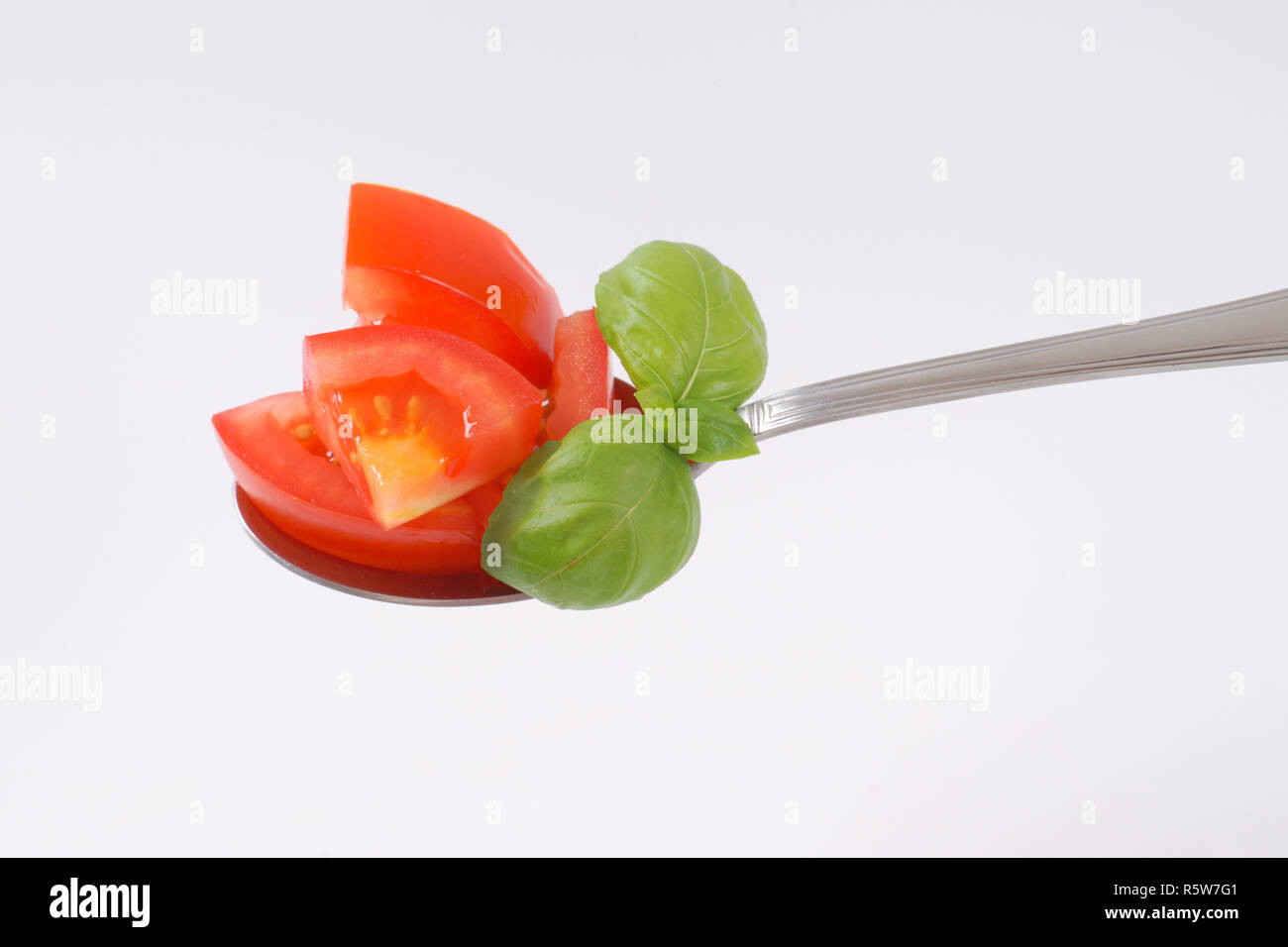 spoon of sliced tomato Stock Photo - Alamy