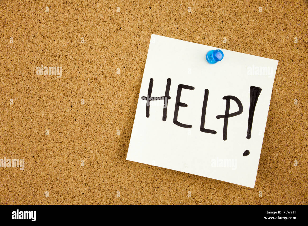 help - word handwritten on a stack of sticky notes posted on cork ...