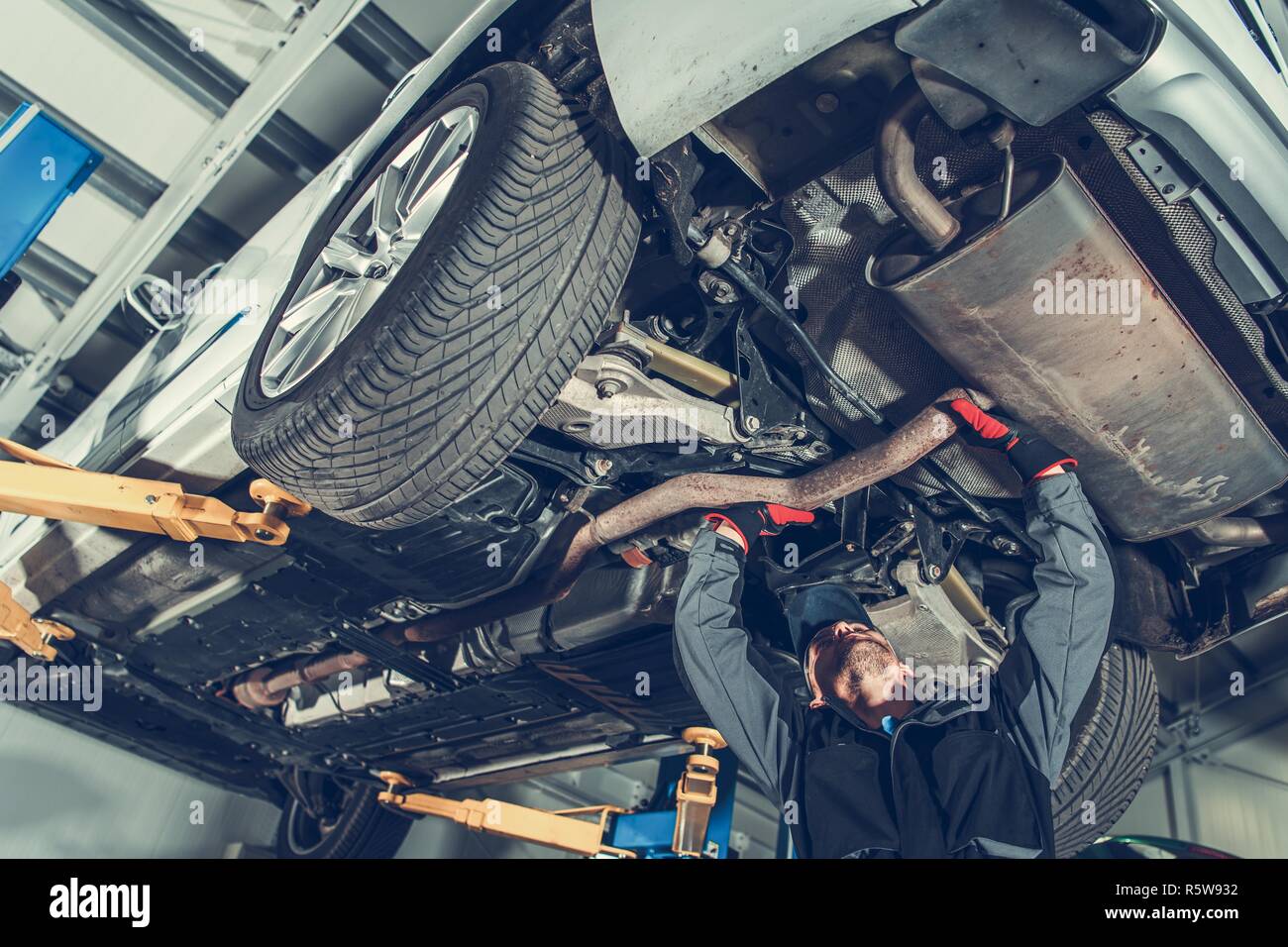 Automotive Mechanic Job. Caucasian Auto Service Worker and the Vehicle ...