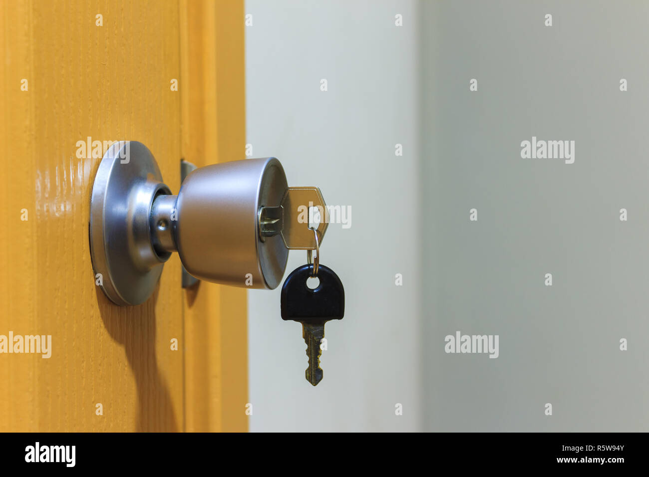 Key in keyhole on door Stock Photo - Alamy