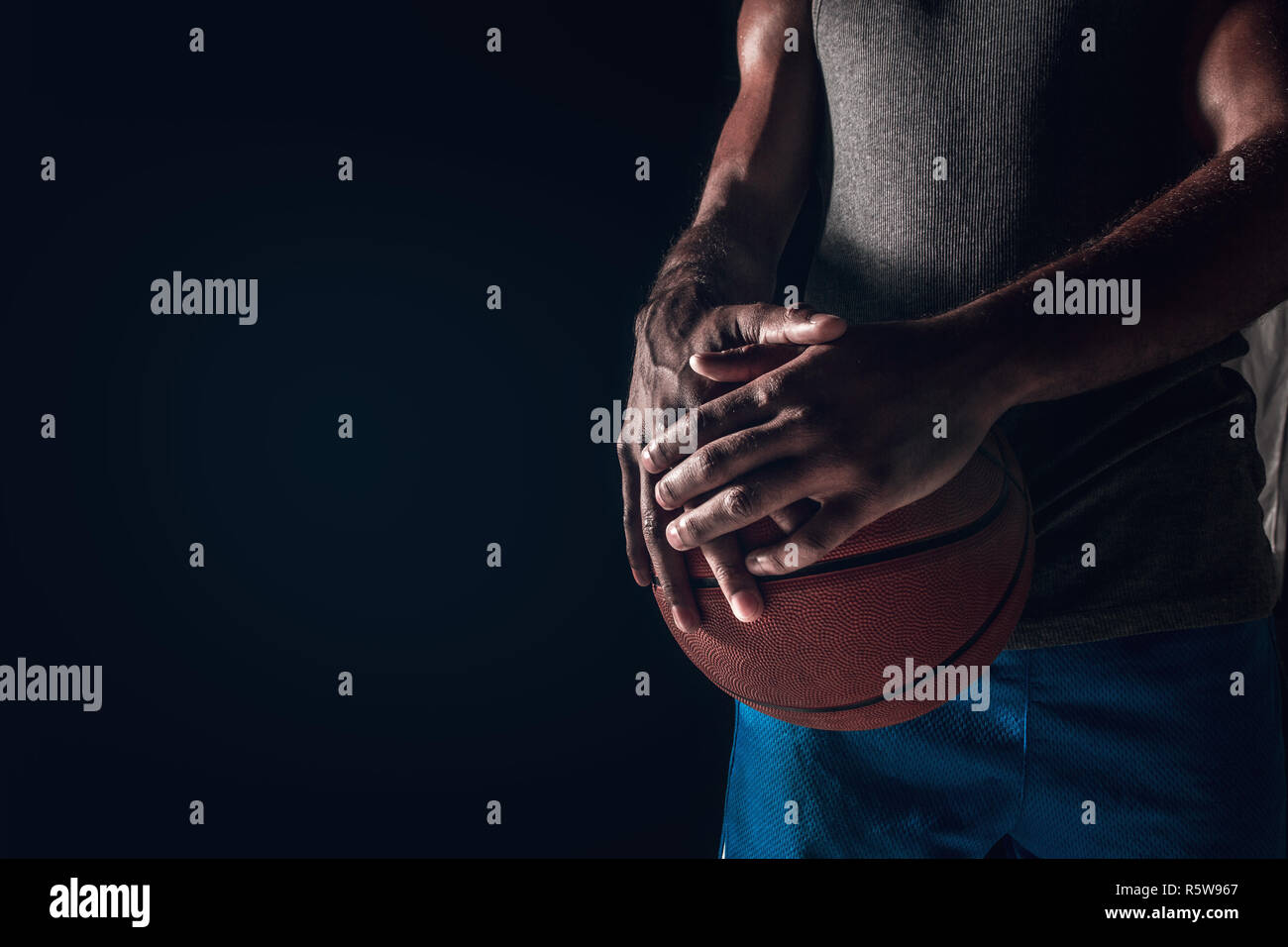 The hands of a basketball player with ball Stock Photo - Alamy