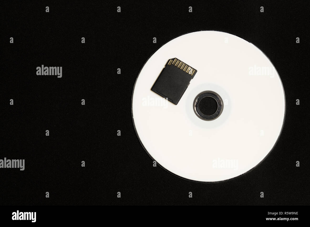 Memory card and digital disc isolated on black background Stock Photo ...