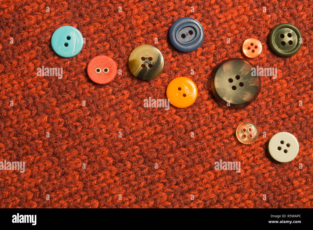 Various sewing buttons on textile background Stock Photo - Alamy