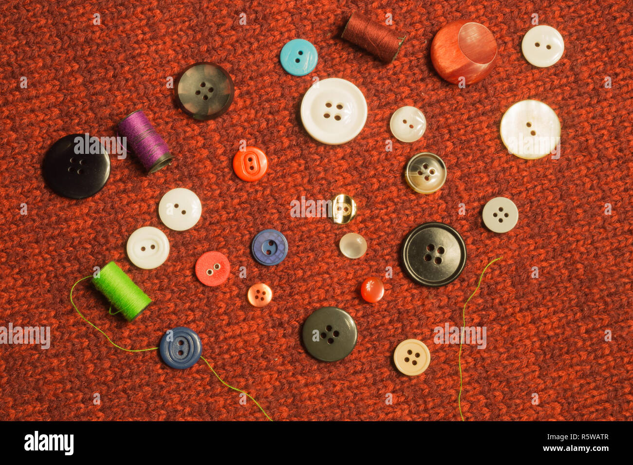 Various sewing buttons on textile background Stock Photo - Alamy