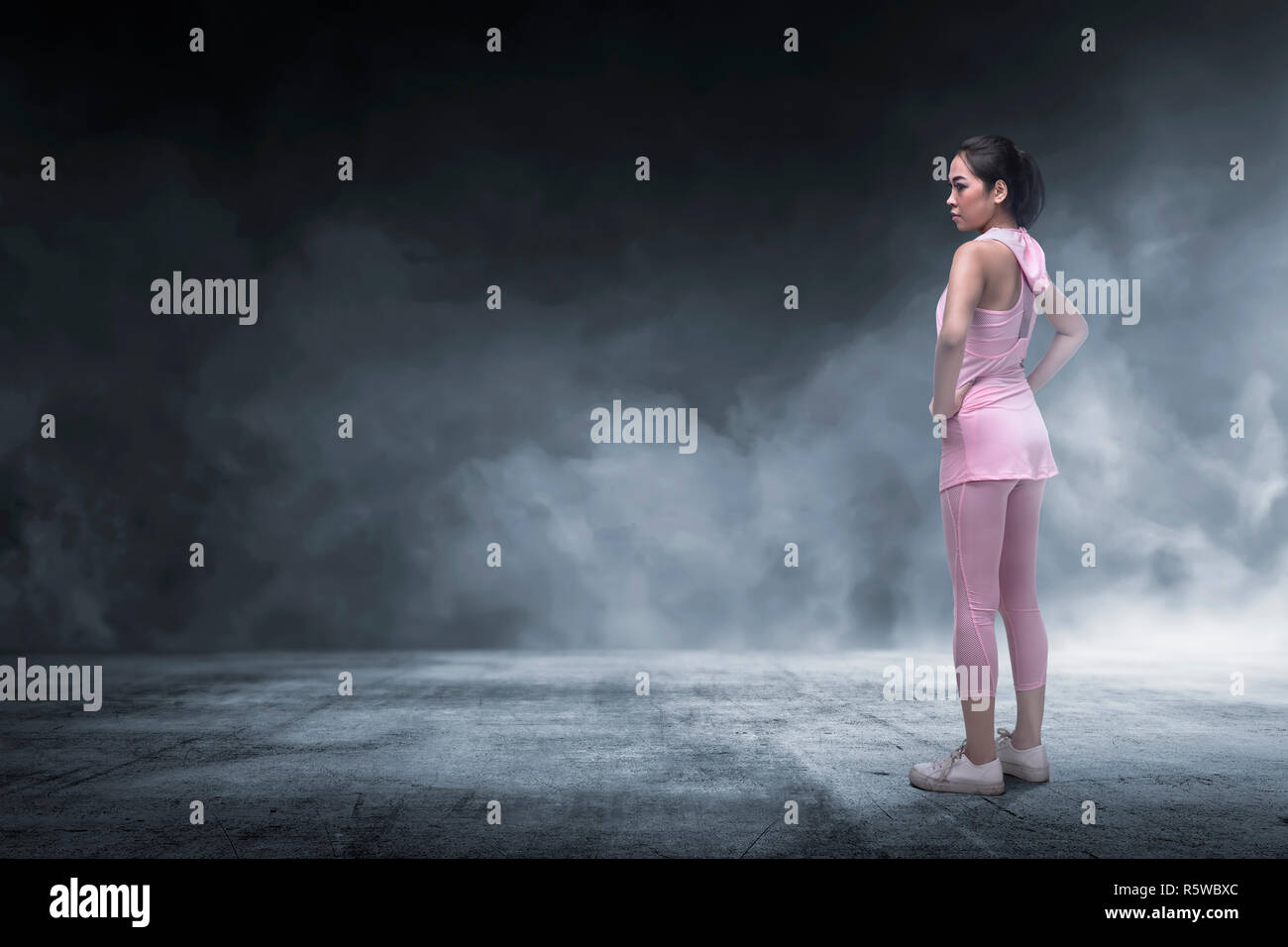 Pretty asian runner woman relaxing after running Stock Photo - Alamy