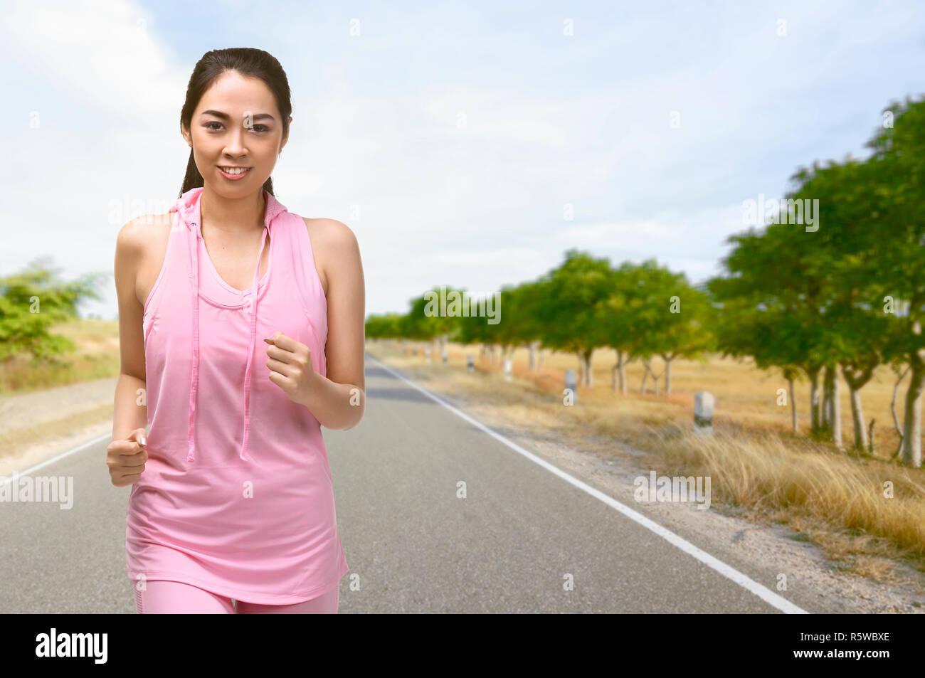 Athletic asian woman running Stock Photo - Alamy