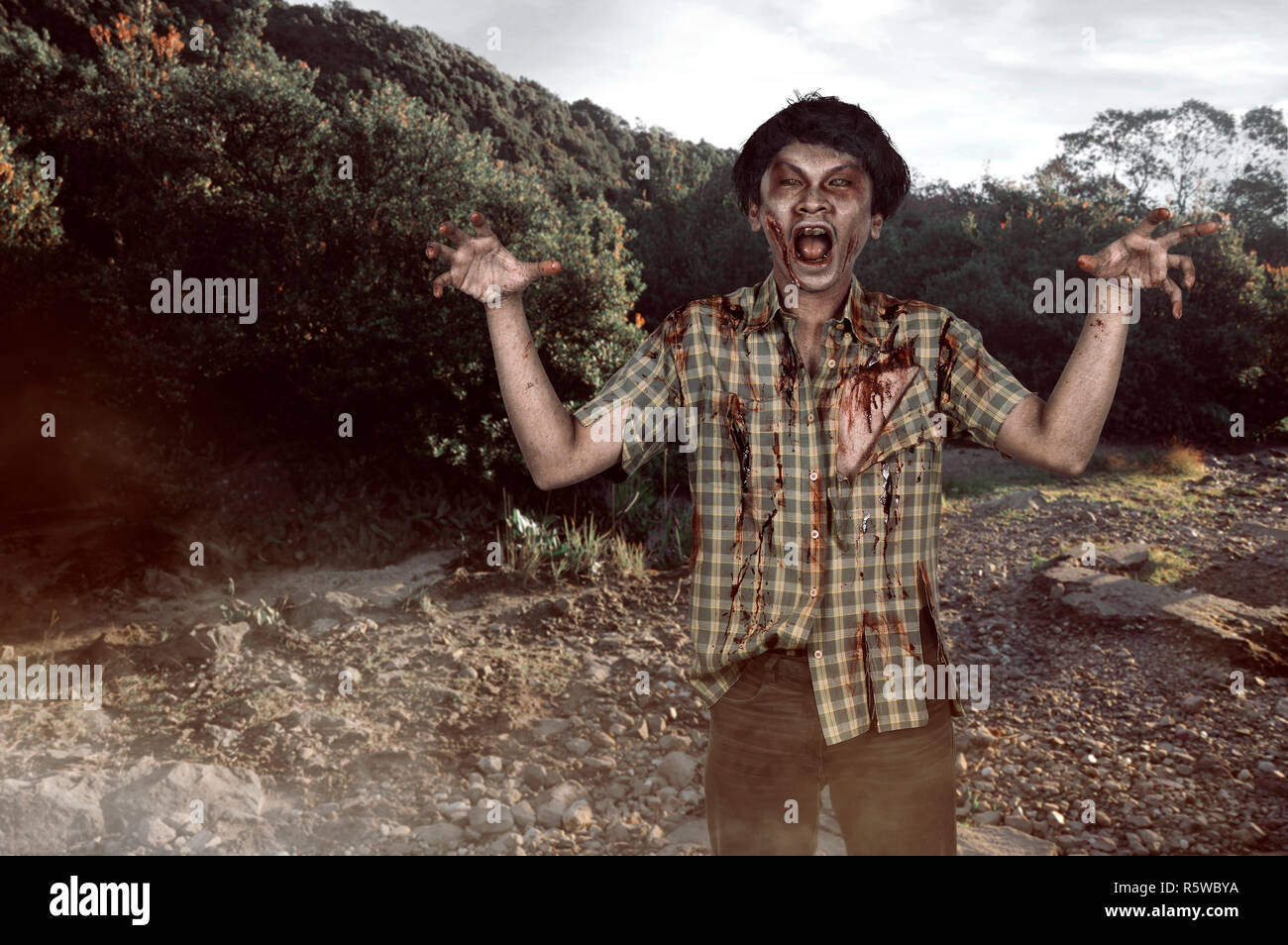 Scary asian zombie man with wounded face and claw hand Stock Photo - Alamy