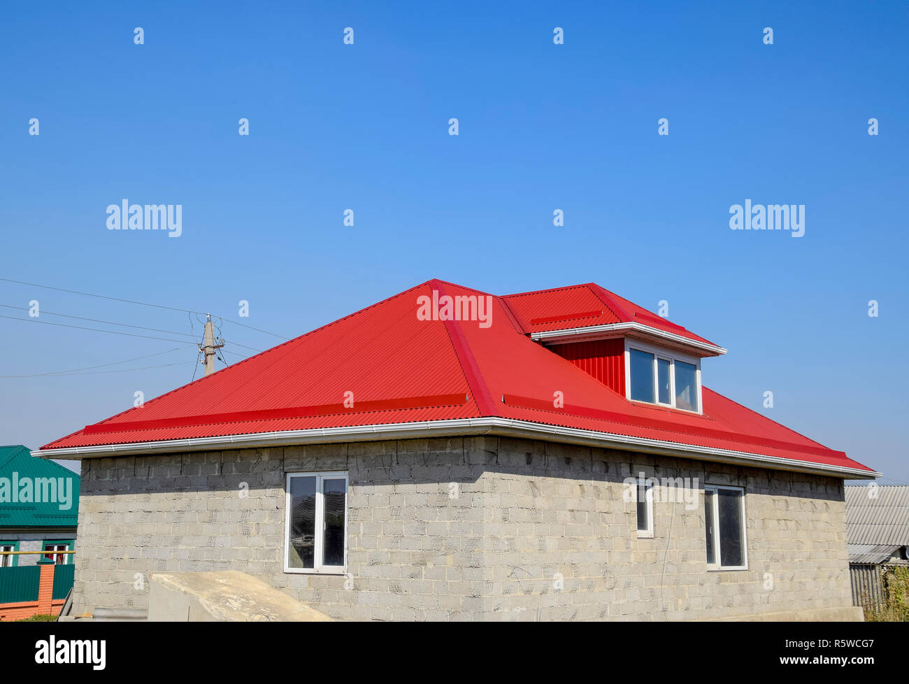 Red corrugated roof. House of cinder block. House with plastic windows ...