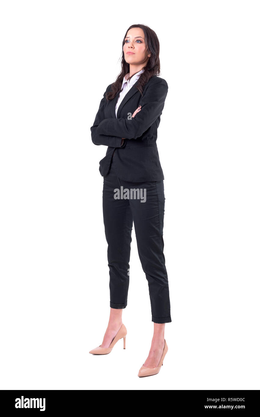 Beautiful bossy female business manager with crossed hands looking up ...