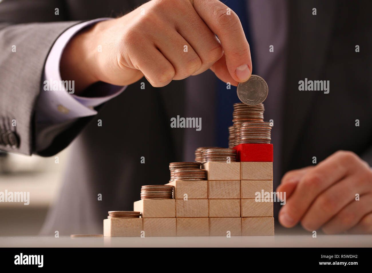 Hand businessman putting pin money Stock Photo - Alamy