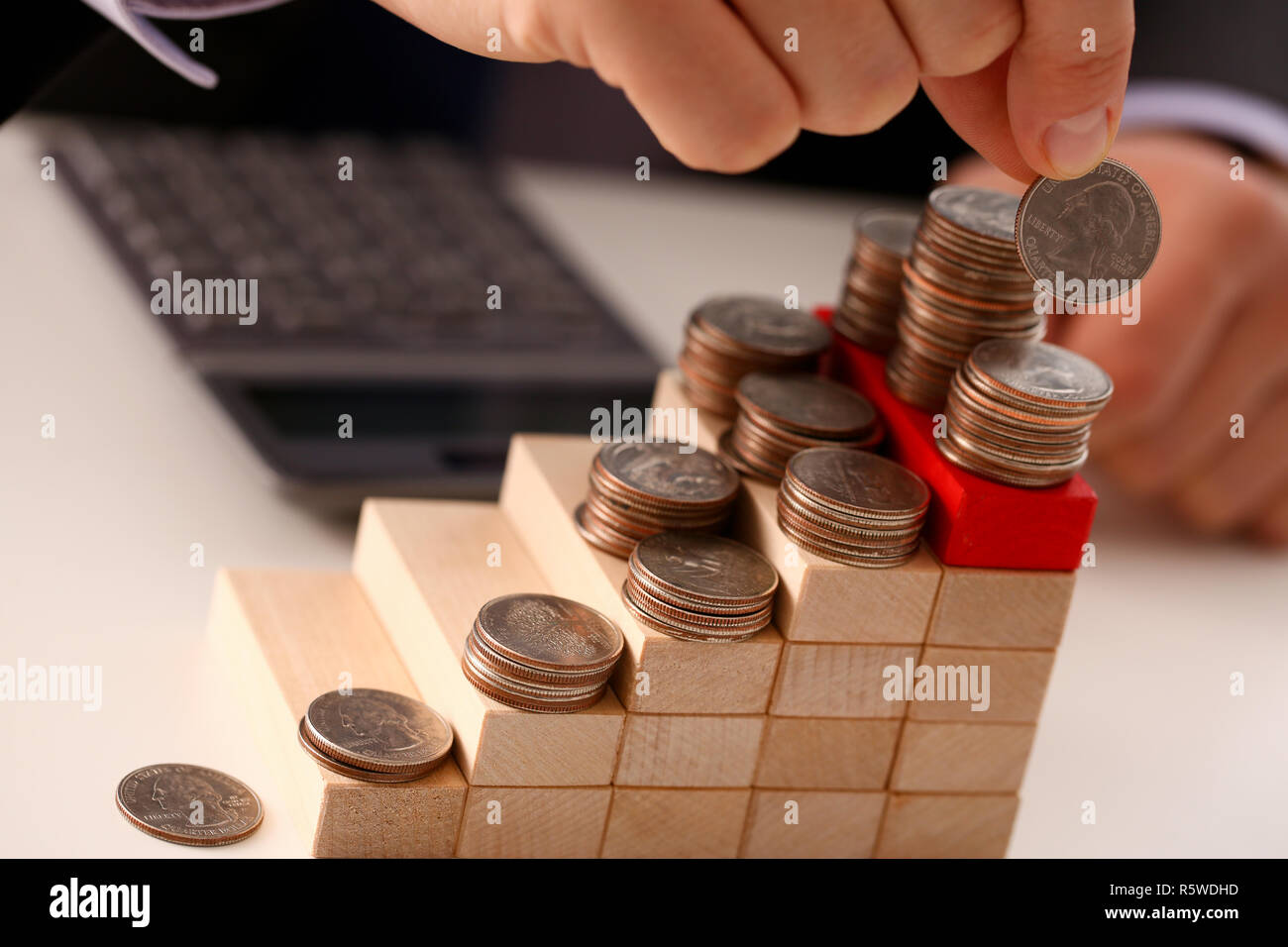 Hand businessman putting pin money Stock Photo - Alamy