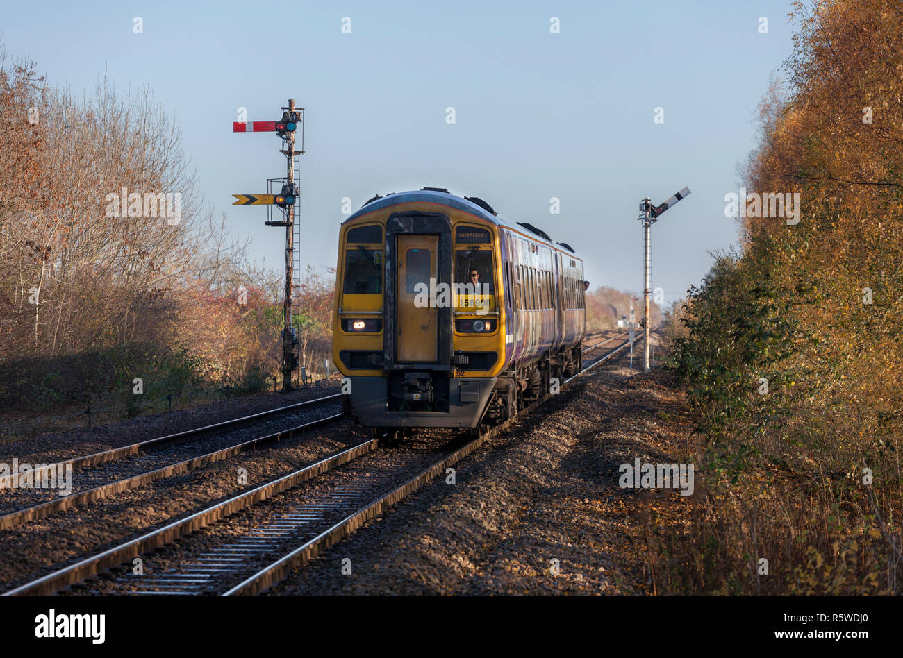 Arriva Northern Rail class 158 sprinter train passing the mechanical semaphore railway signals ...