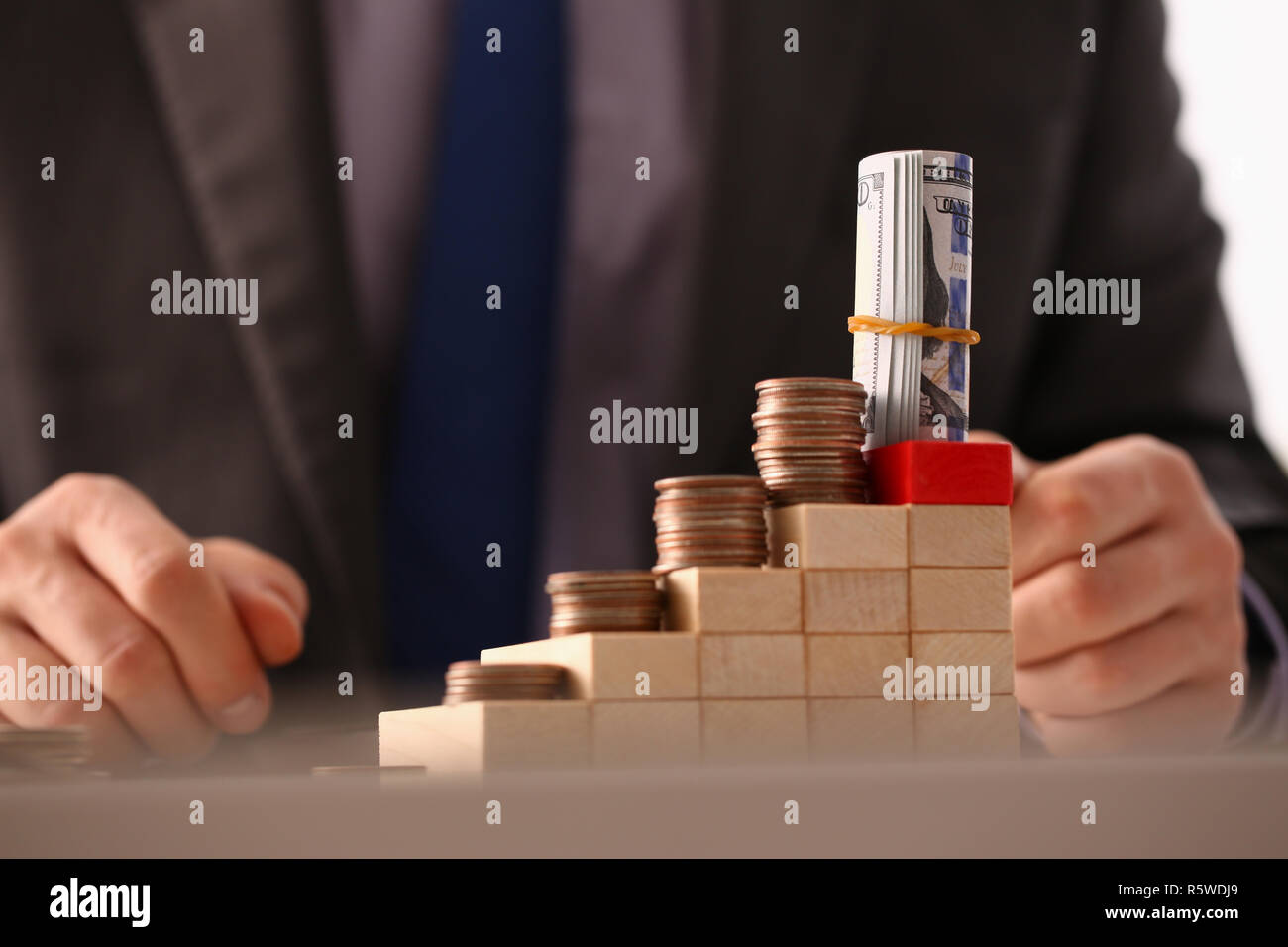 Hand businessman putting pin money Stock Photo - Alamy