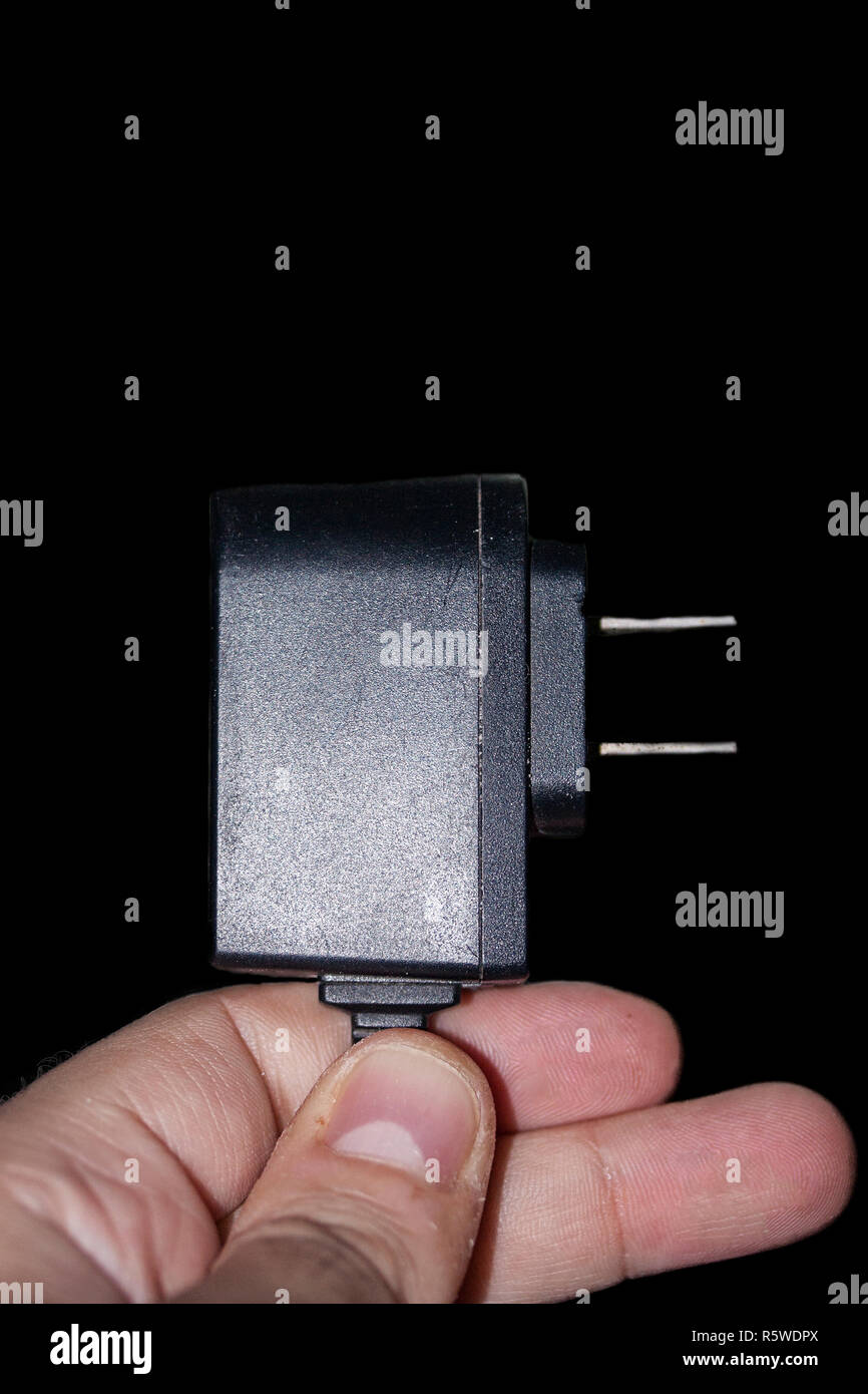 charger hand plug power electric Stock Photo - Alamy