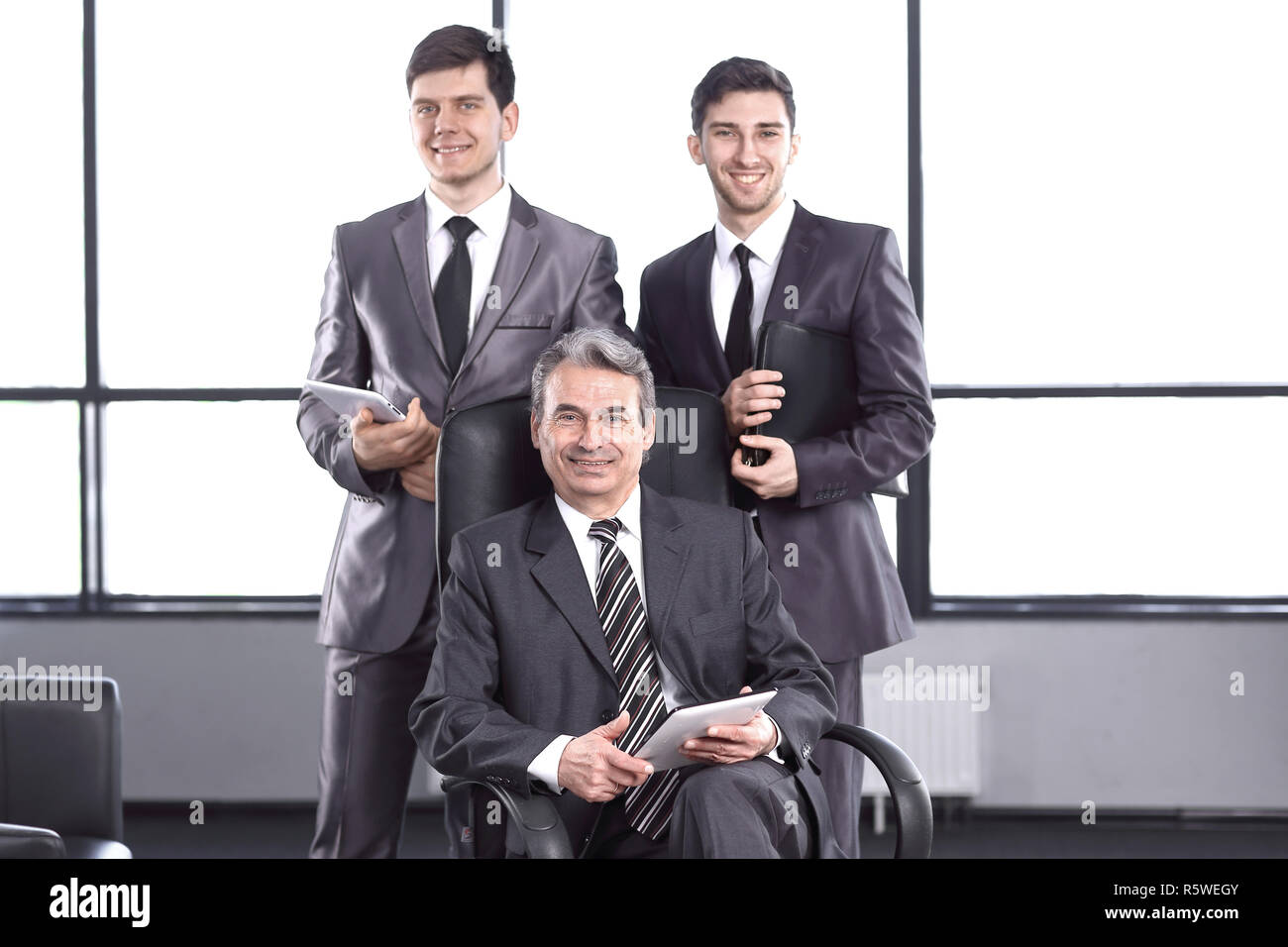businessman and two assistants with buffers. business people Stock ...