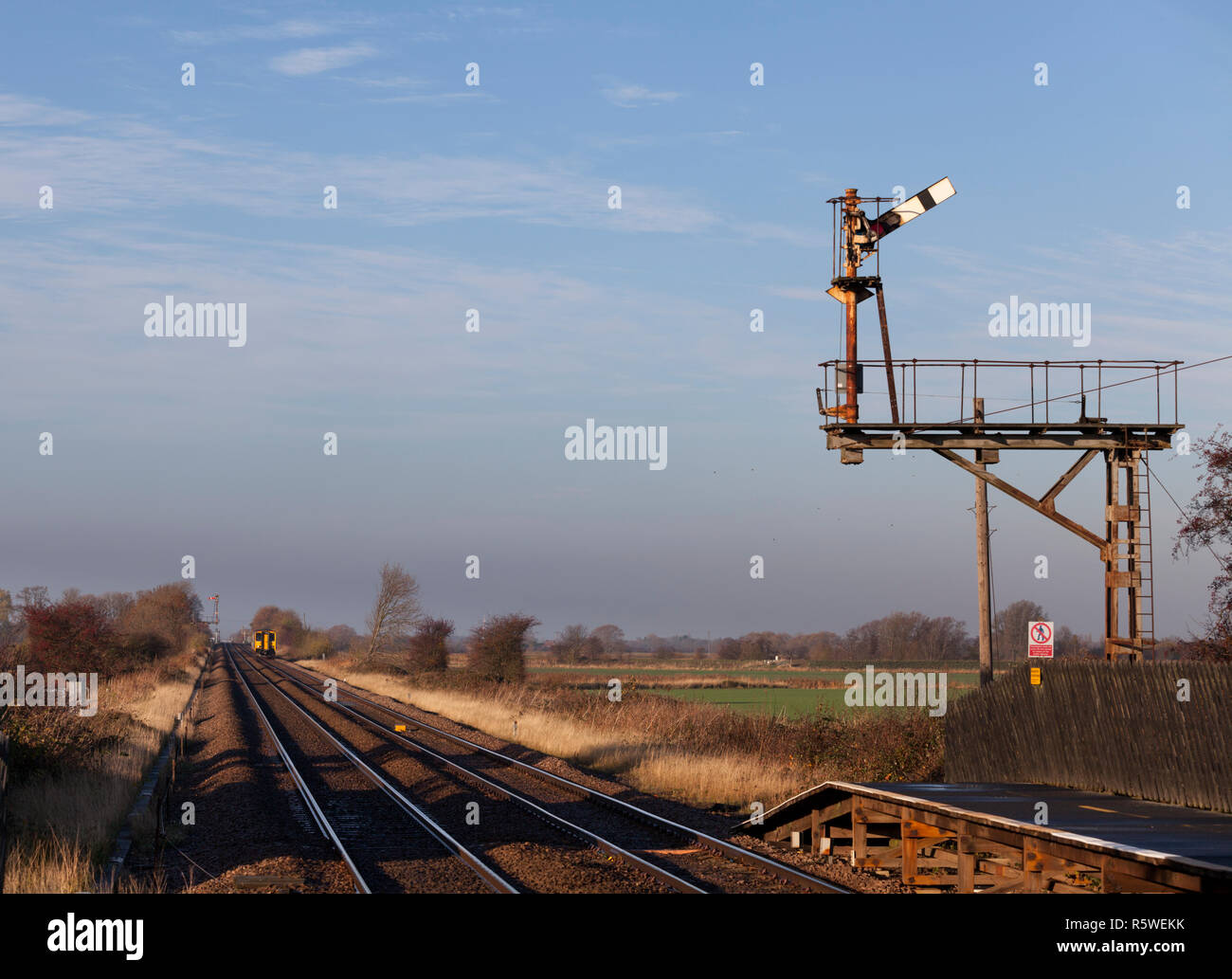 Arriva rail Northern class 150 sprinter train passing the semaphore bracket signals at ...